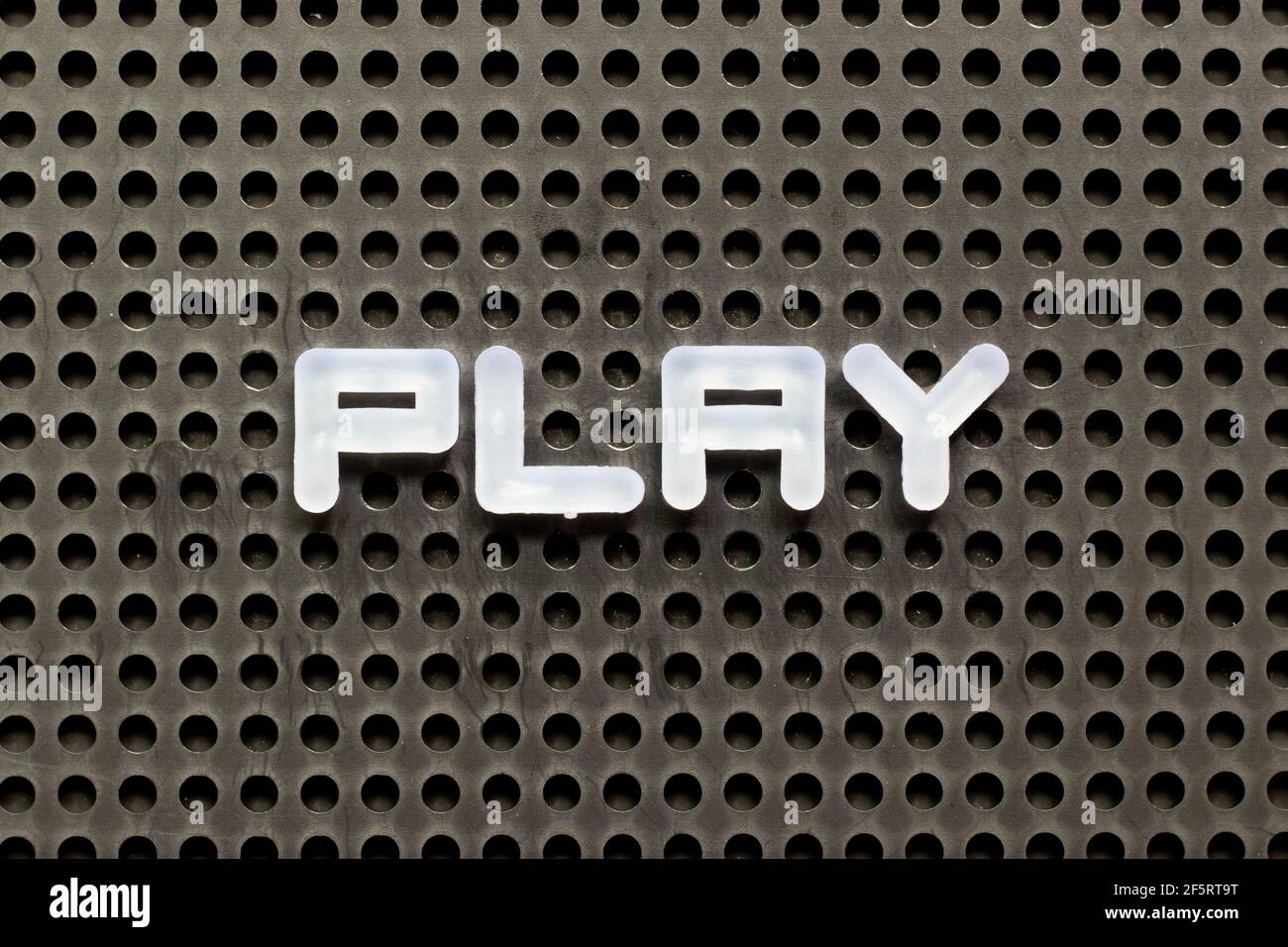 White color letter in word play on black pegboard background Stock ...