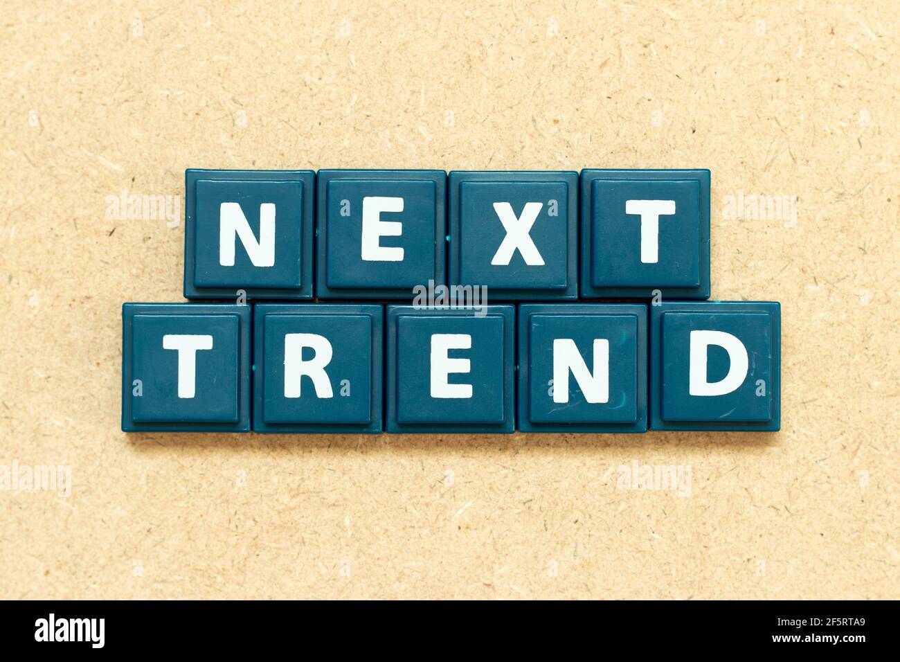 Tile alphabet letter in word next trend on wood background Stock Photo ...