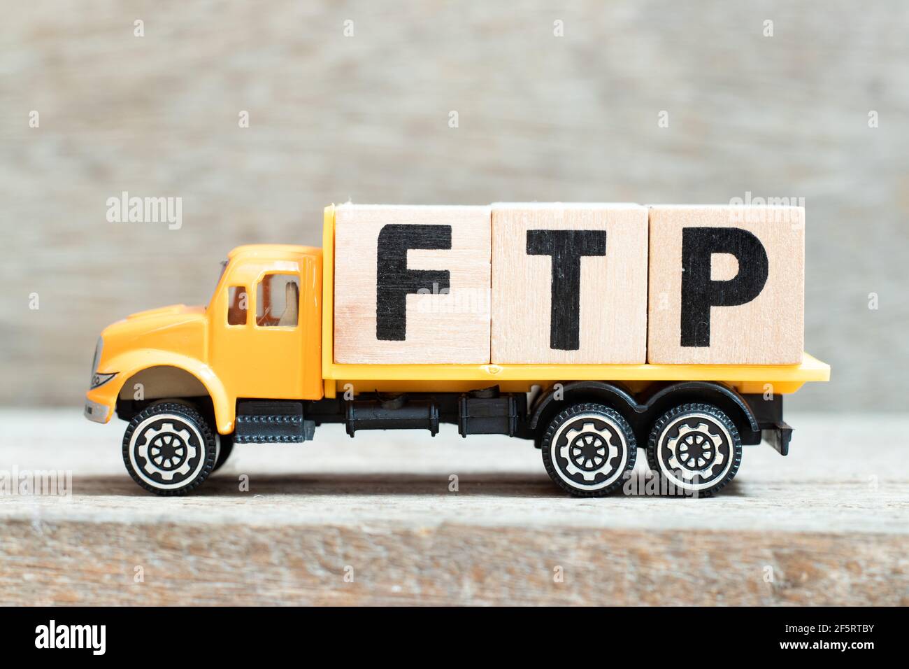 Toy truck hold alphabet letter block in word FTP (Abbreviation of File ...