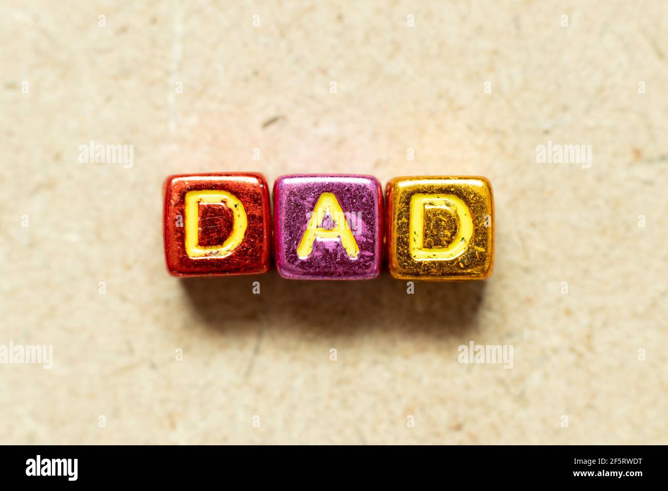 Metallic color alphabet letter block in word dad on wood background ...