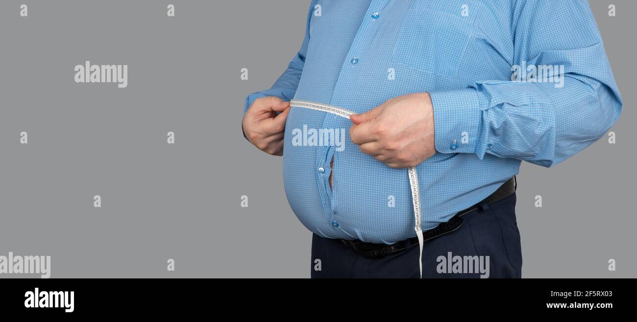 fat guy measures the size of the abdomen with a centimeter measuring ...