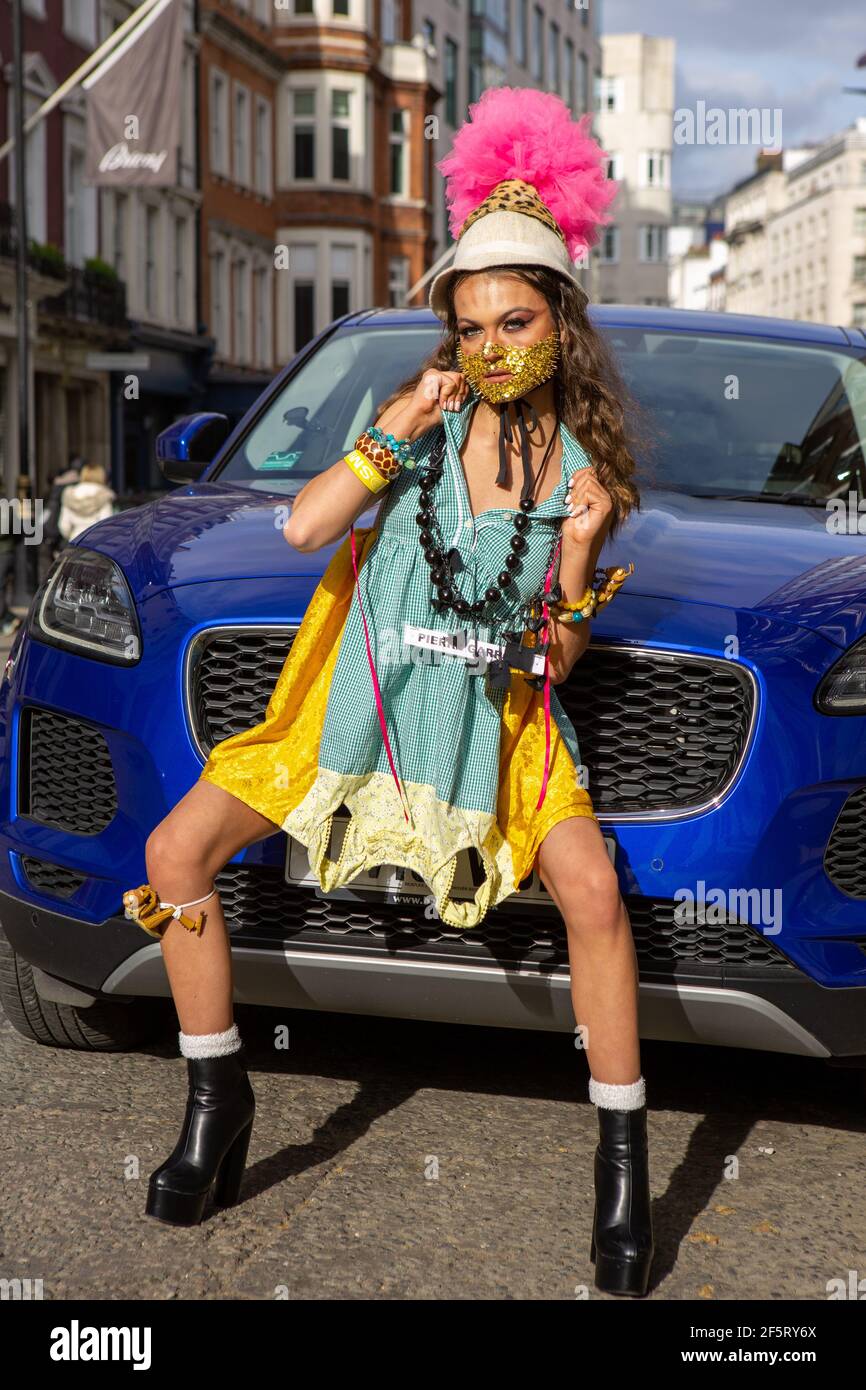 A model showcases Pierre Garroudi's latest colourful collection at one ...