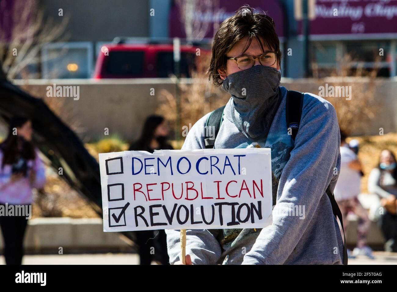 A protest holding a placard calling for a revolution during a ...