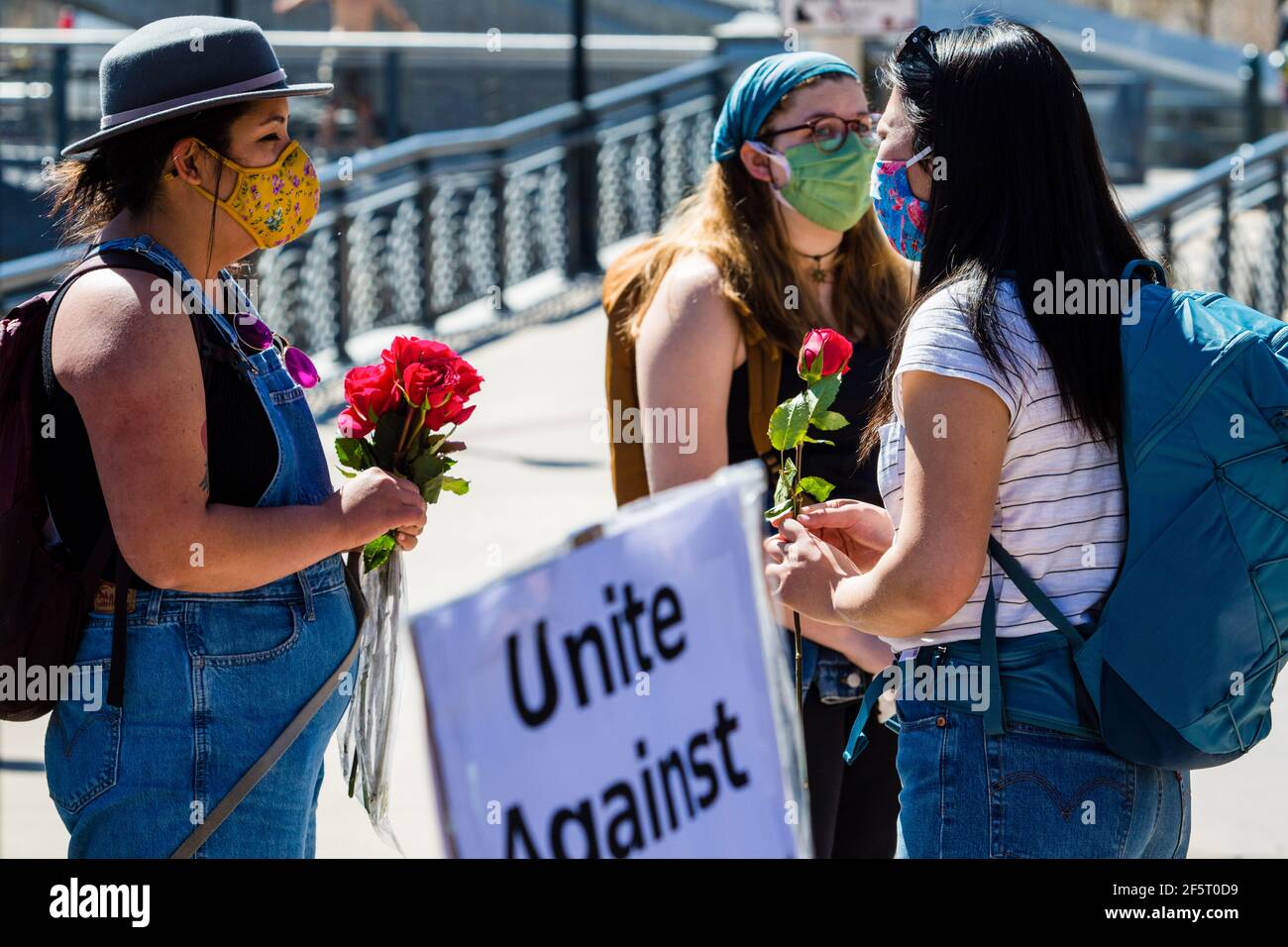 Reno, United States. 27th Mar, 2021. Protestors holding rose flowers ...