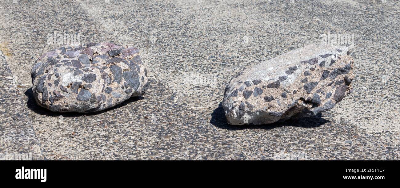 2 lumps of concrete have been tossed by the waves back onto a slab of ...