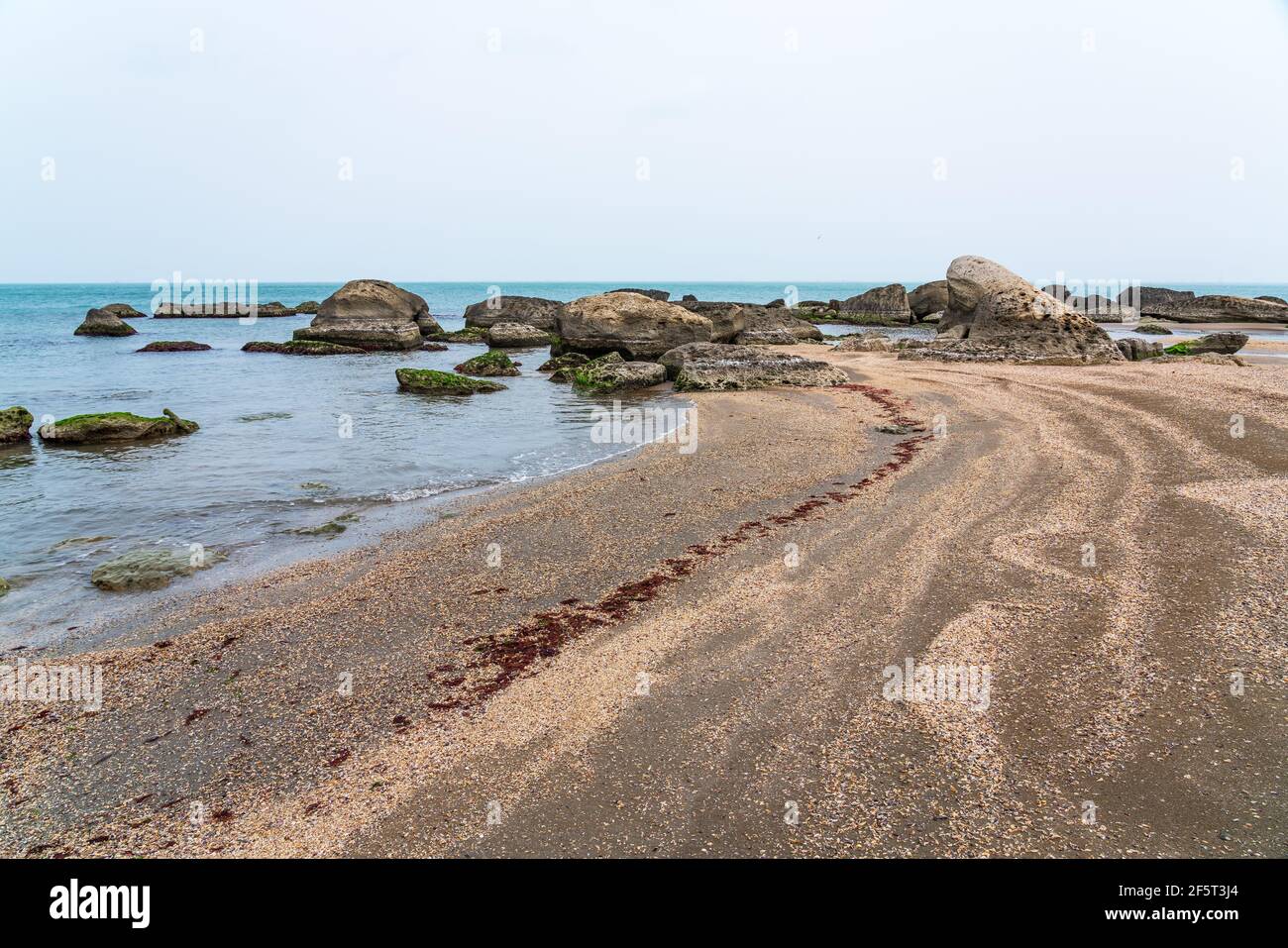 Rocky sea beach with boulders Stock Photo - Alamy