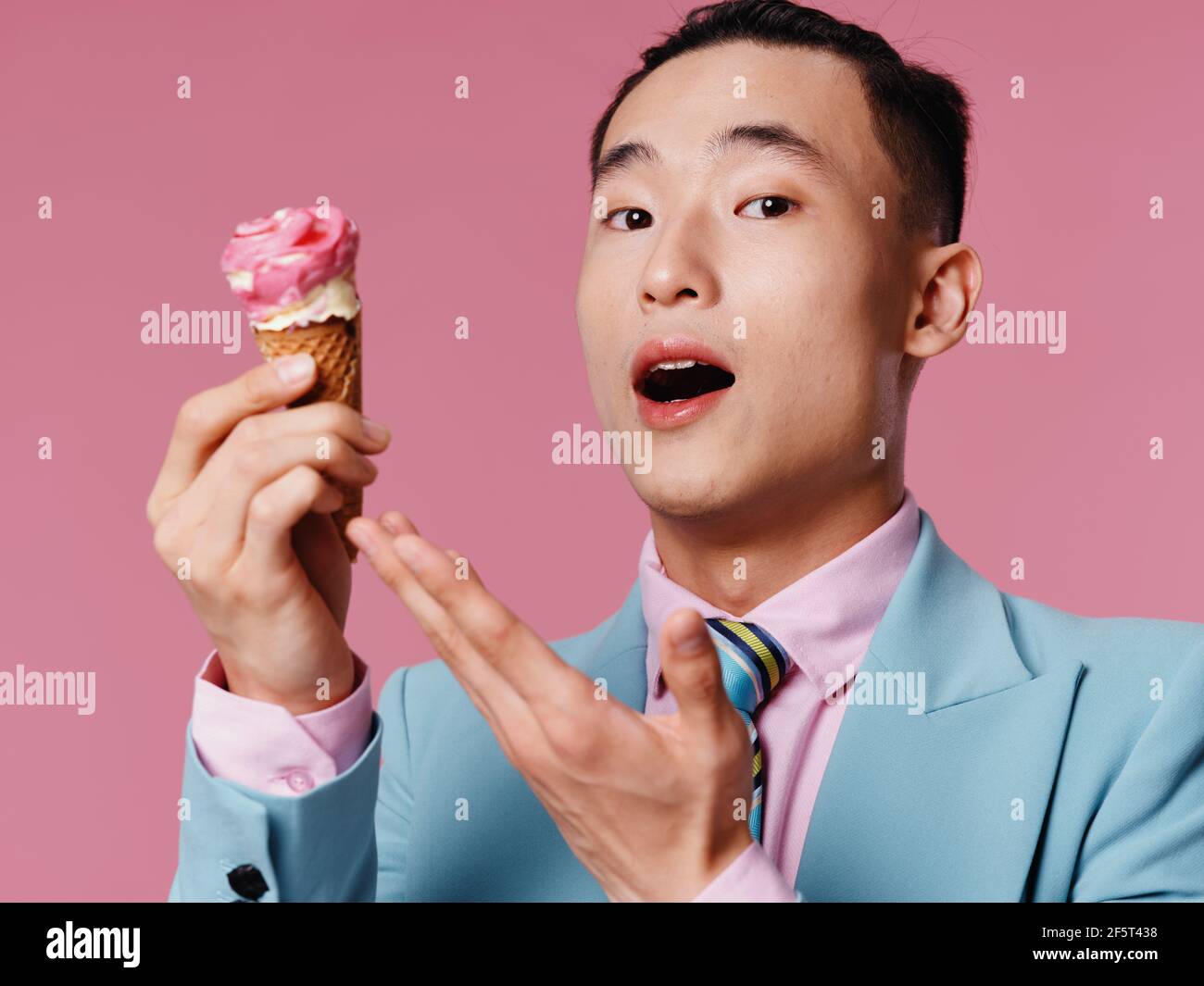 Man with ice cream in suit at party holidays fun model Stock Photo - Alamy