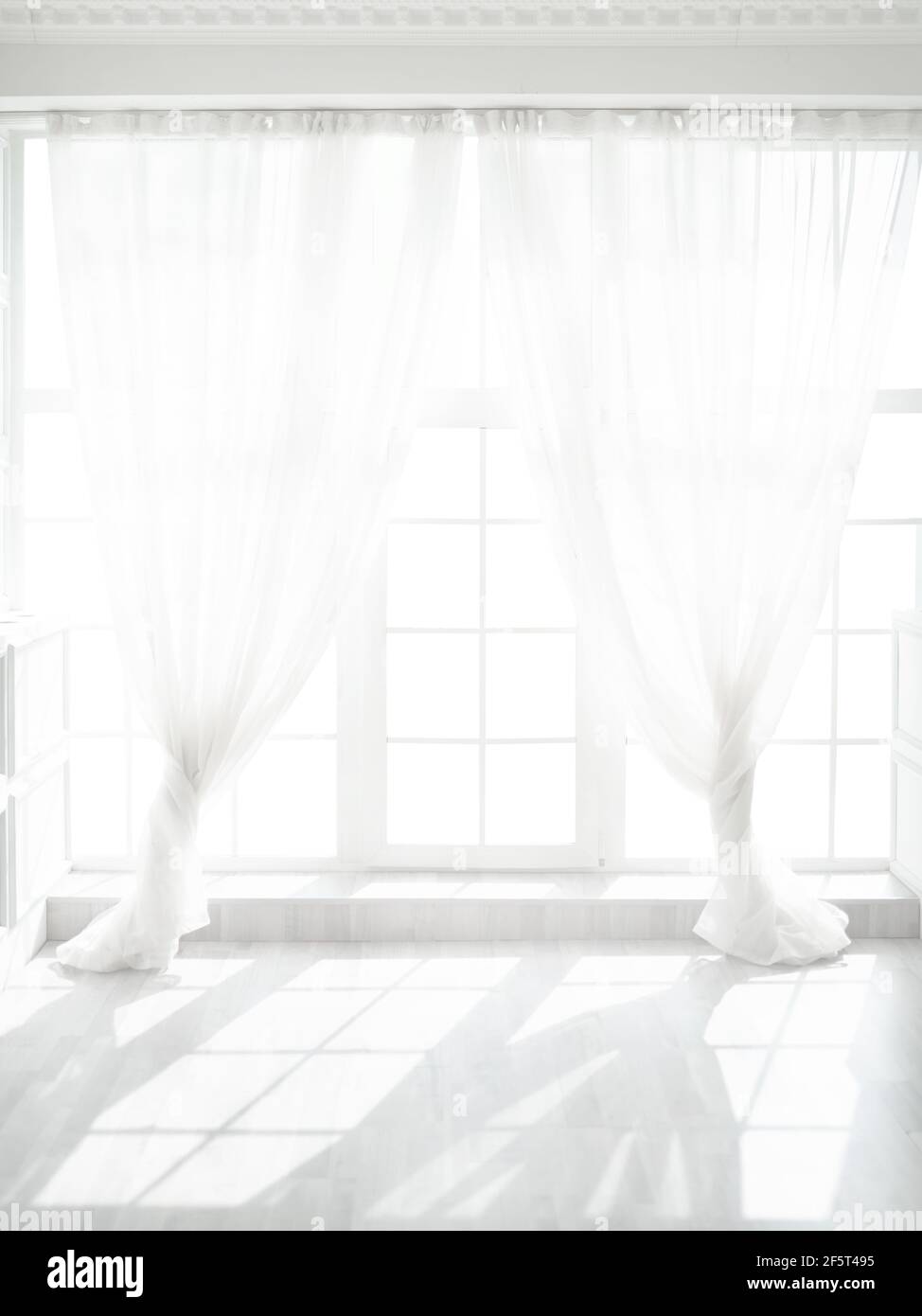 Backlit window with white curtains in empty room Stock Photo - Alamy