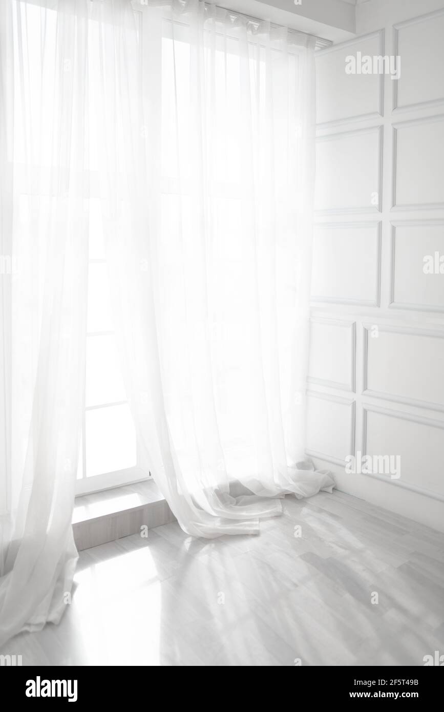 Backlit window with white curtains in empty room Stock Photo - Alamy