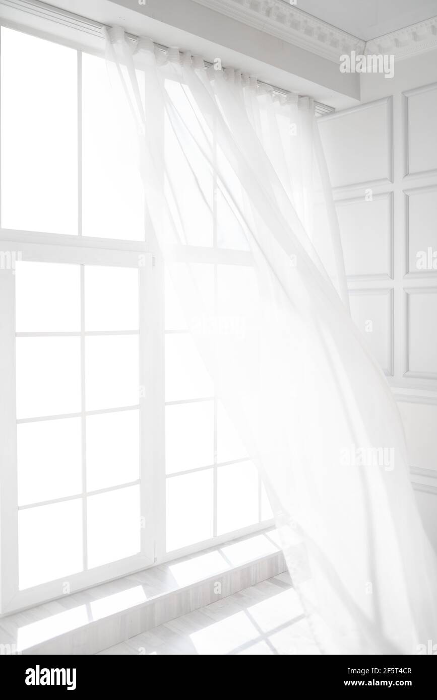 Backlit window with white curtains in empty room Stock Photo - Alamy