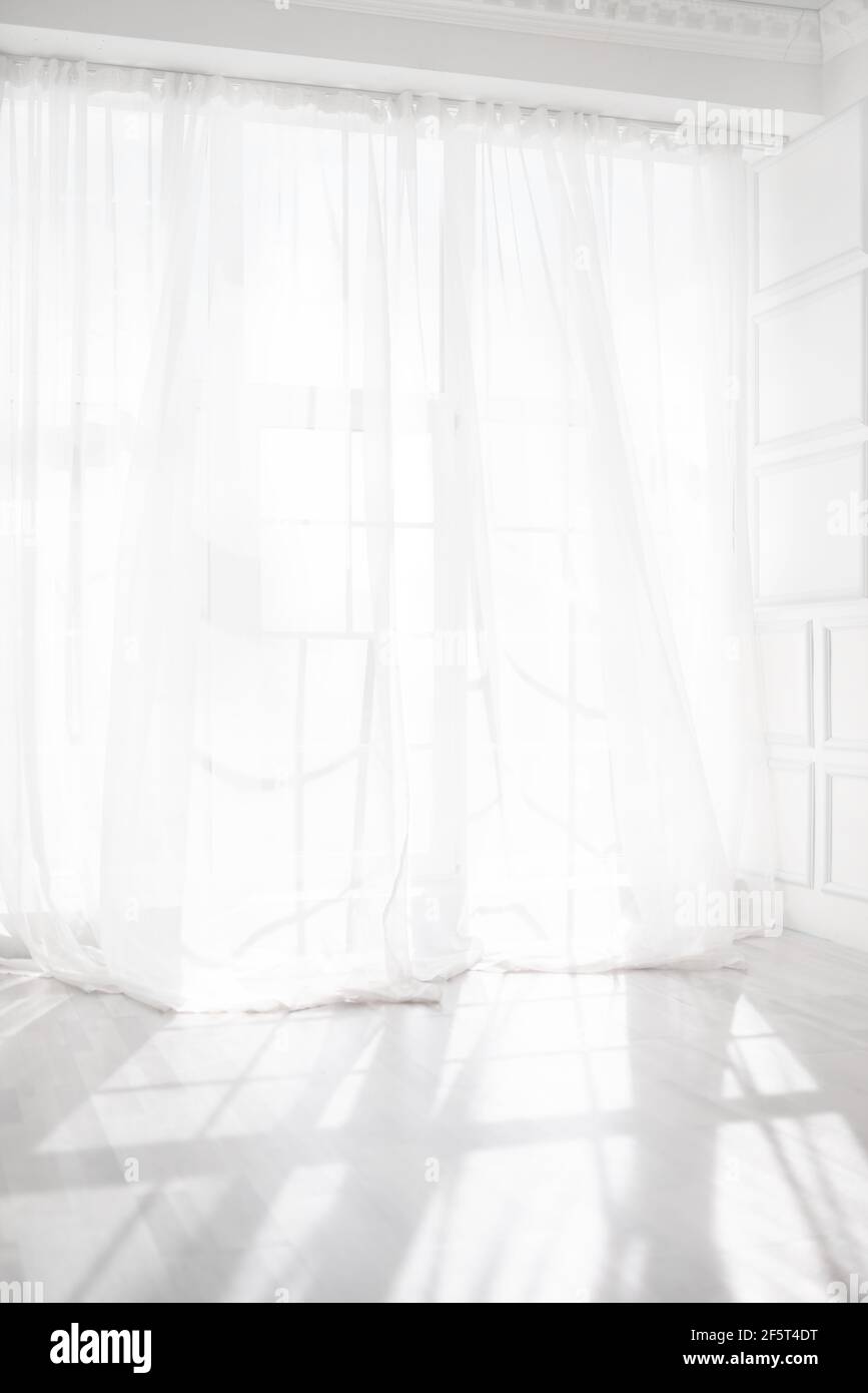 Backlit window with white curtains in empty room Stock Photo - Alamy