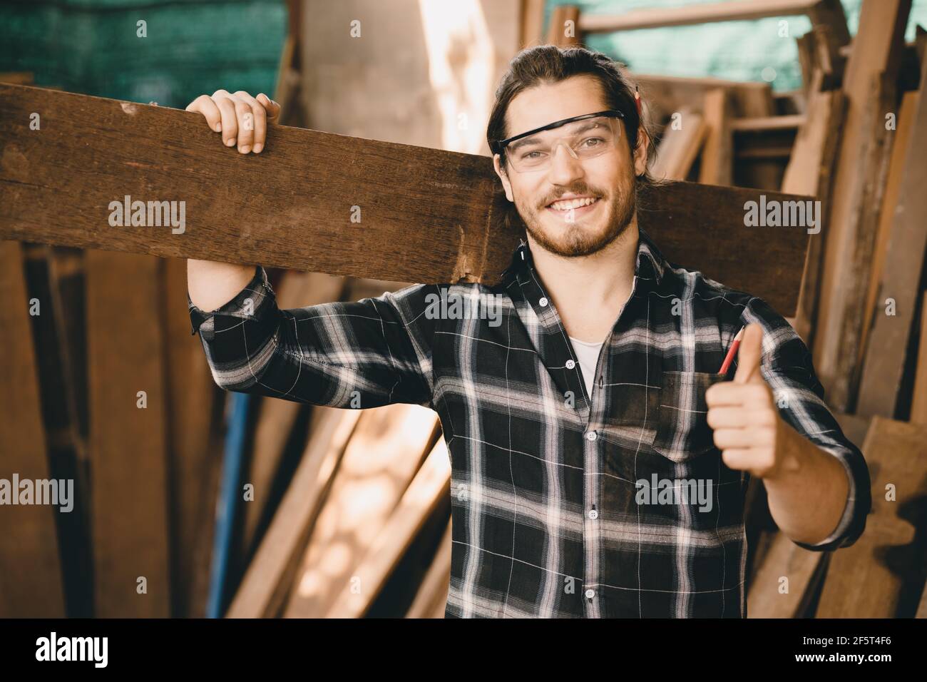 Portrait of Carpenter young SME furniture shop owner smiling in wood ...