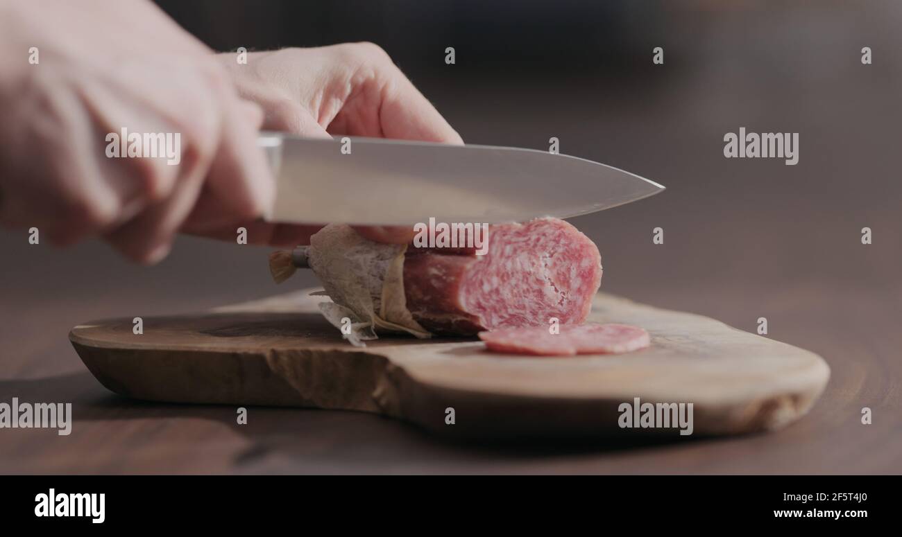 Salami slices hand hi-res stock photography and images - Alamy