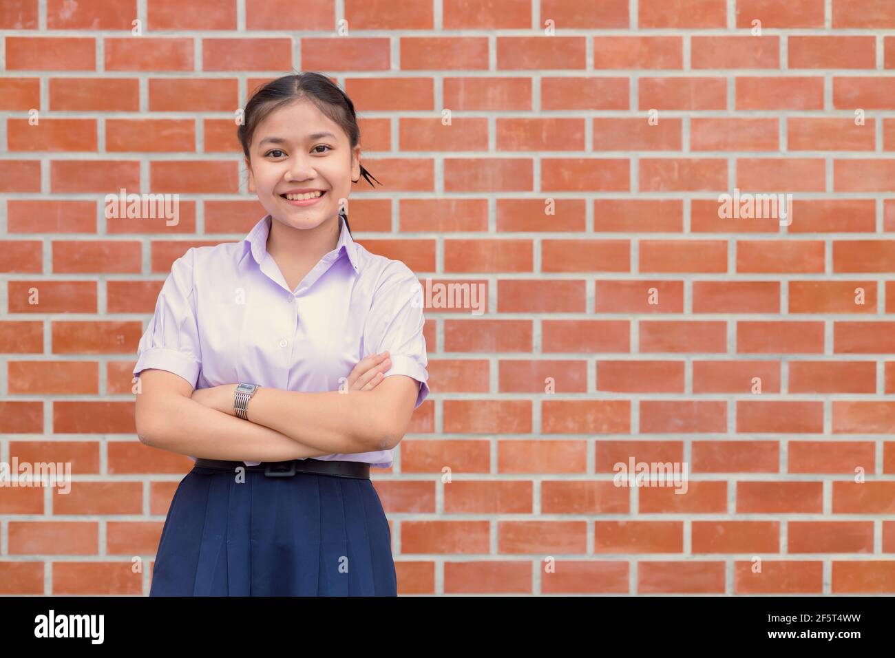 Confident Asian Woman Student Arm Crossed uniform happy smile with ...