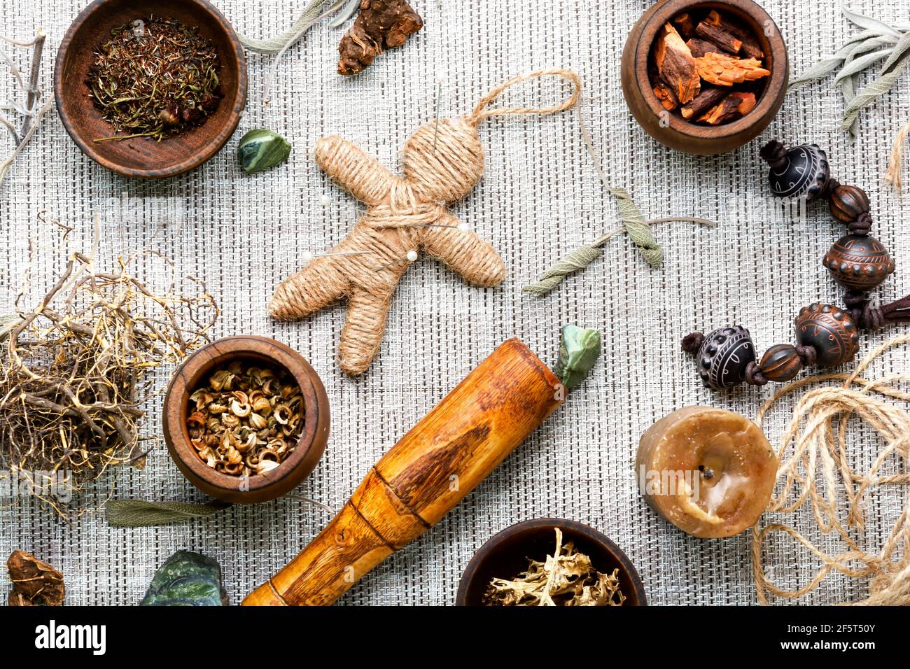 Voodoo doll,magical herbs and witchcraft attributes on an old table ...