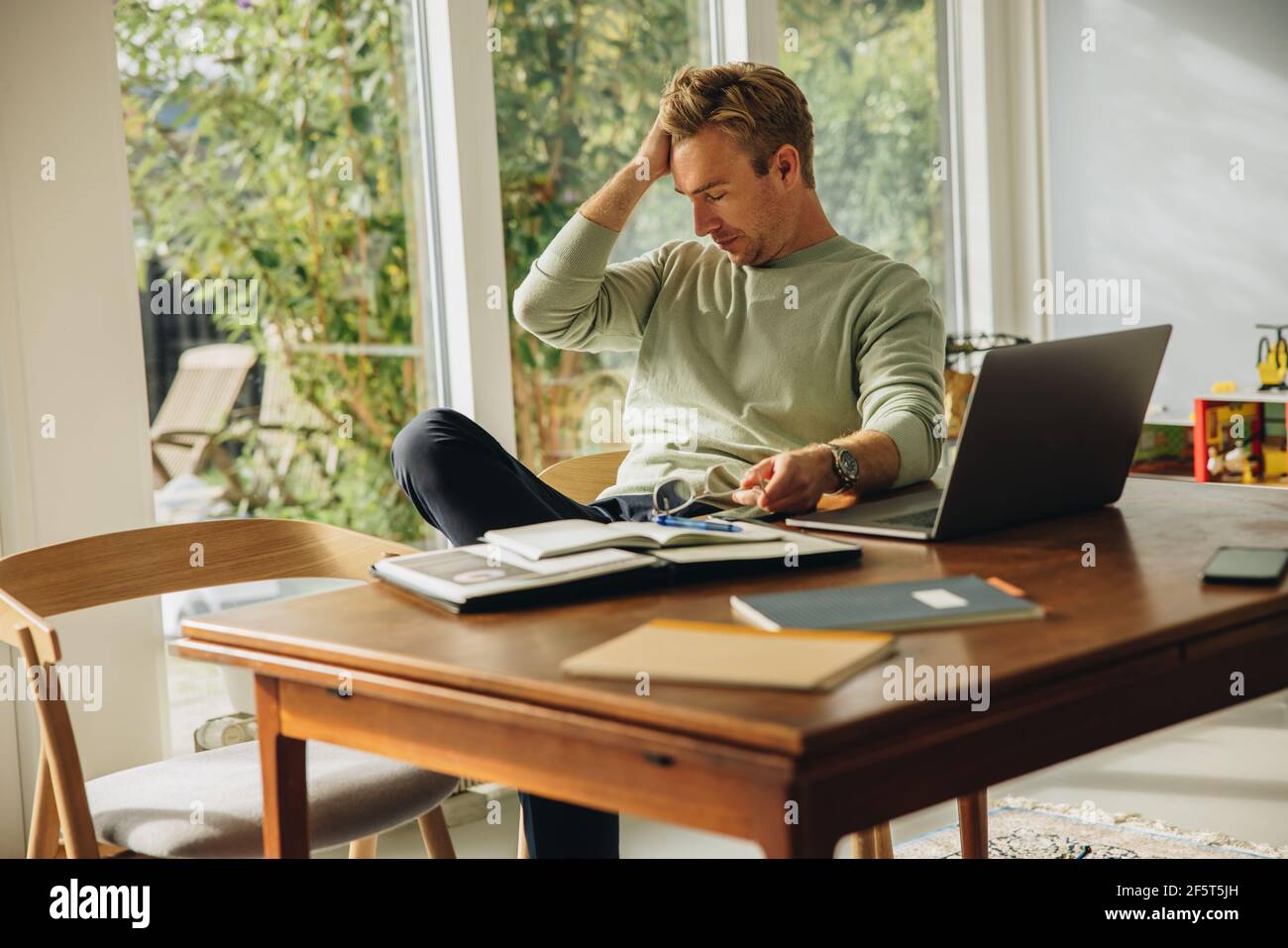 Man looking tired after working long hours at home. business man ...