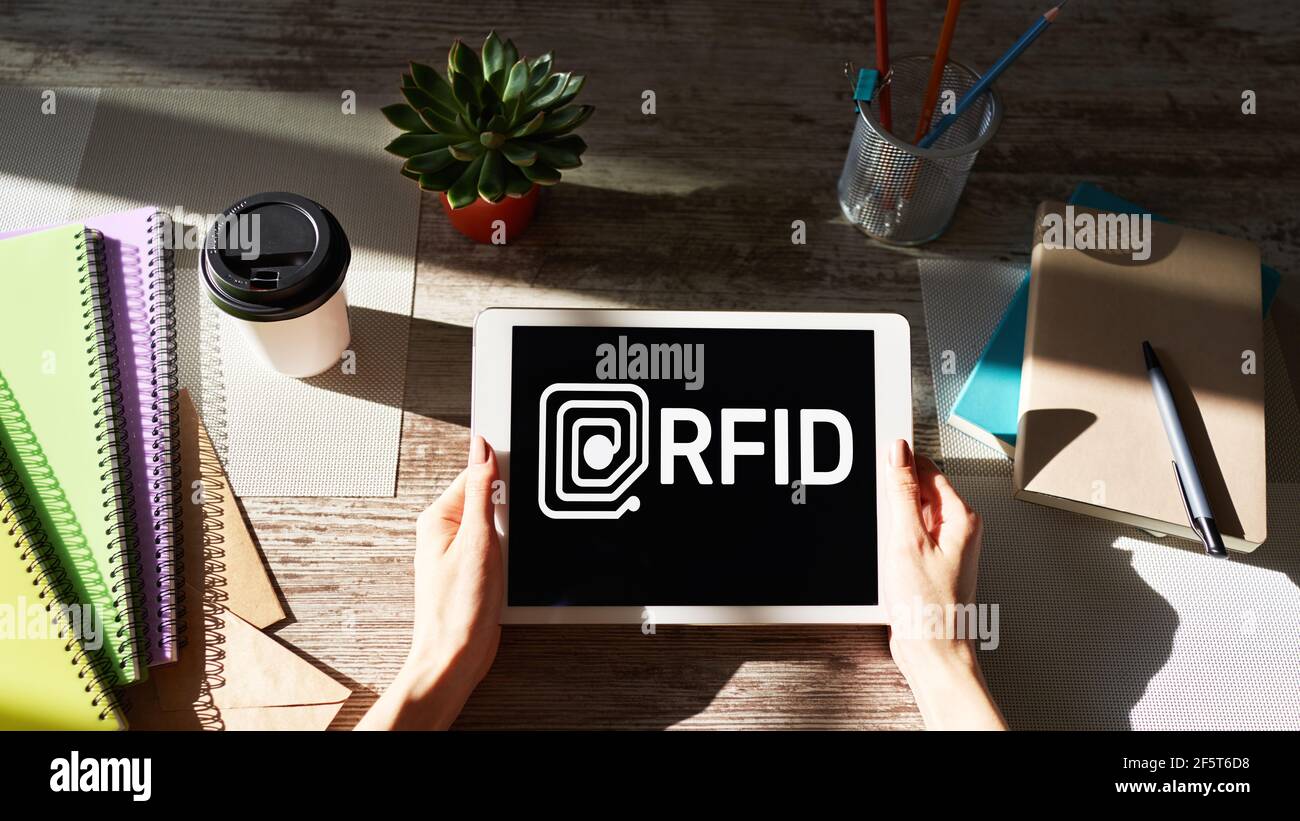 RFID Radio frequency identification technology concept on device screen ...