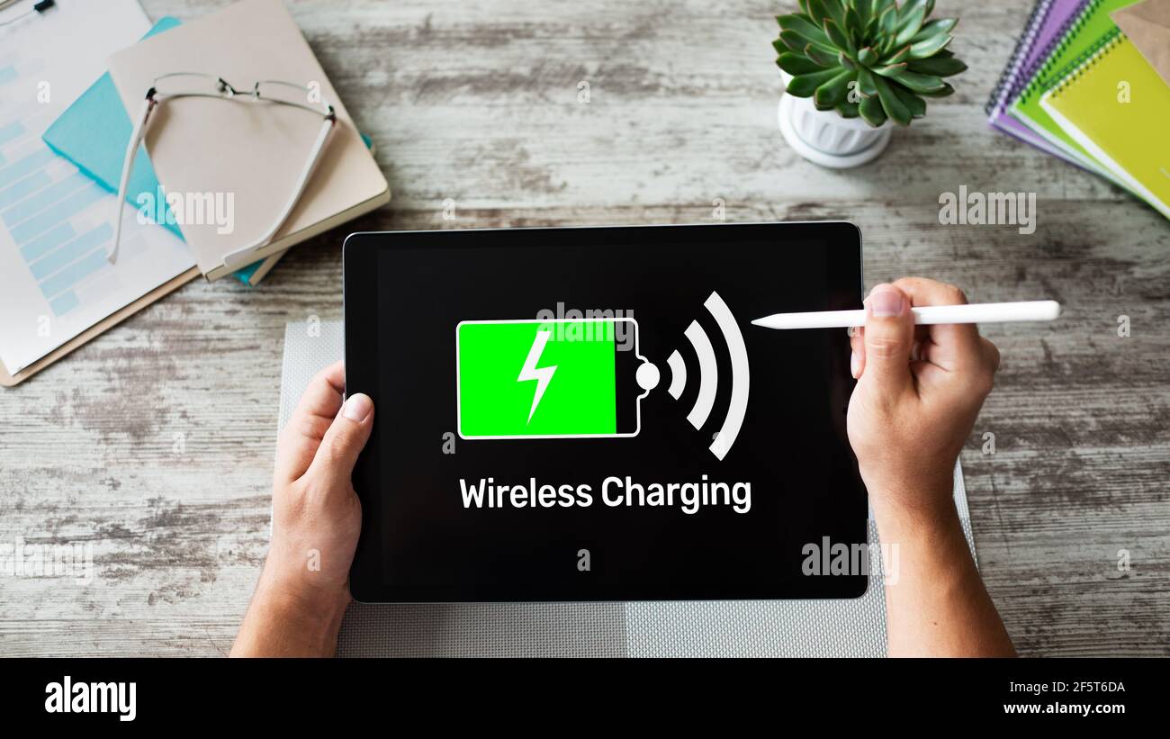 Wireless charging icons and progress bar on device screen Stock Photo ...