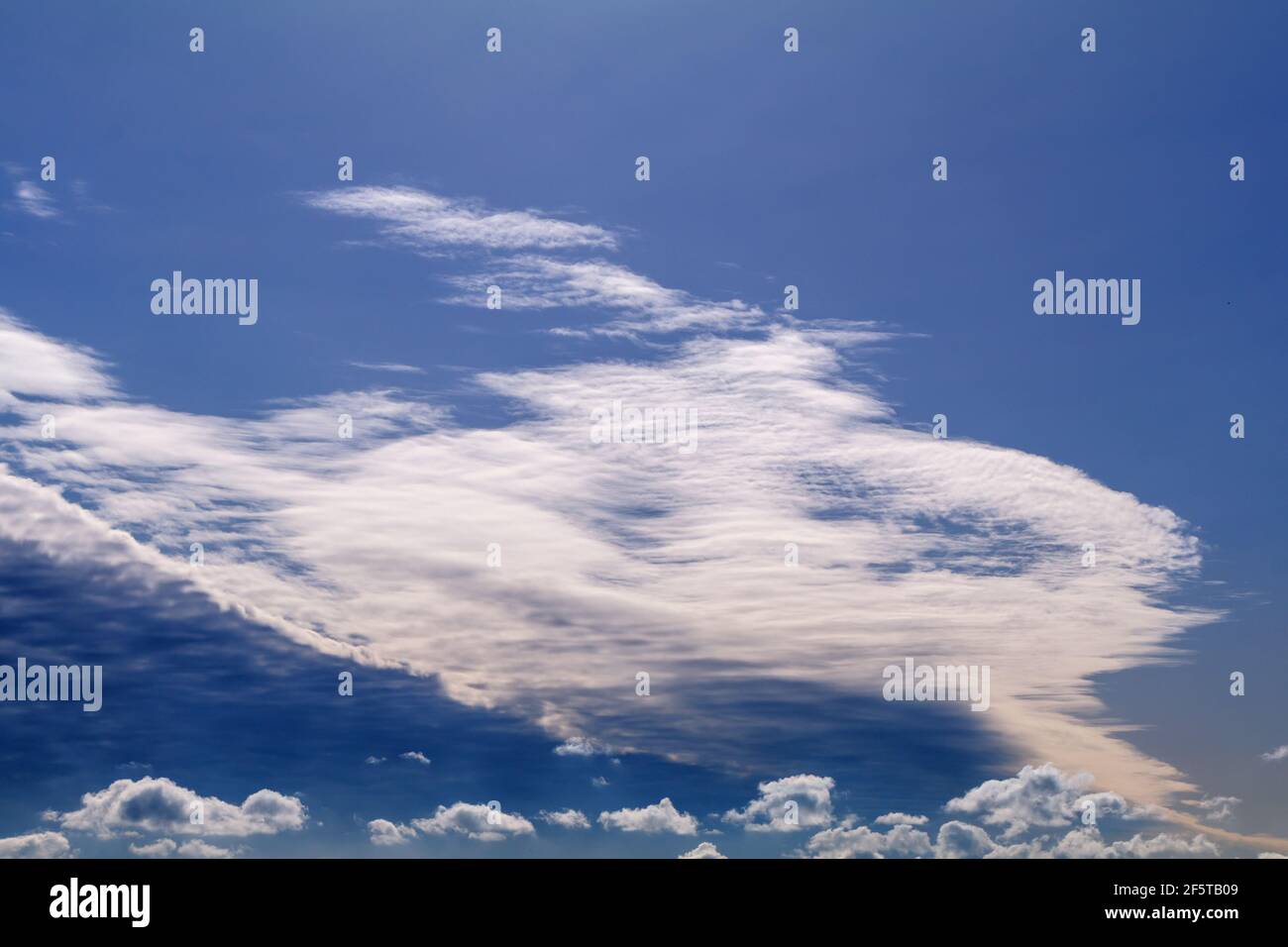 Clouds against a blue sky Stock Photo - Alamy