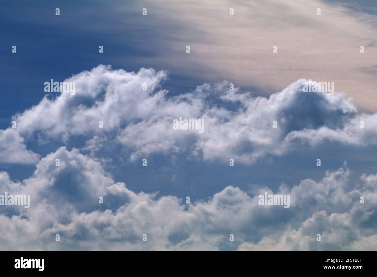 Clouds against a blue sky Stock Photo - Alamy