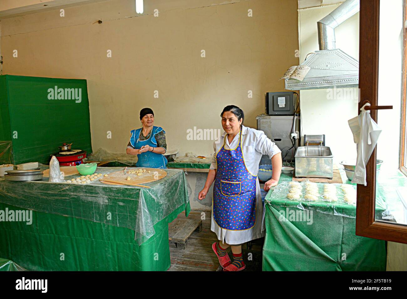 Preparation of qutab, an Azerbaijani dish made from thinly rolled pasta ...