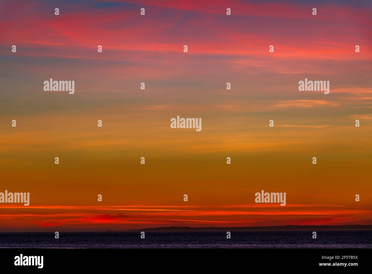 The setting sun lighting up the cloud cover Stock Photo - Alamy