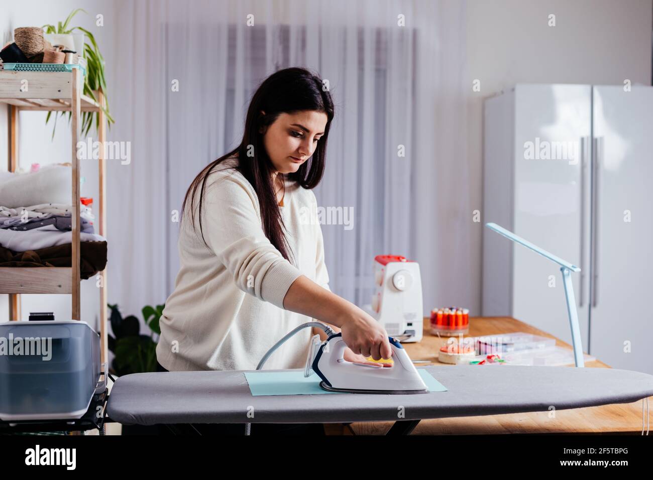 Process of ironing textile before cutting the pattern and sewing Stock ...
