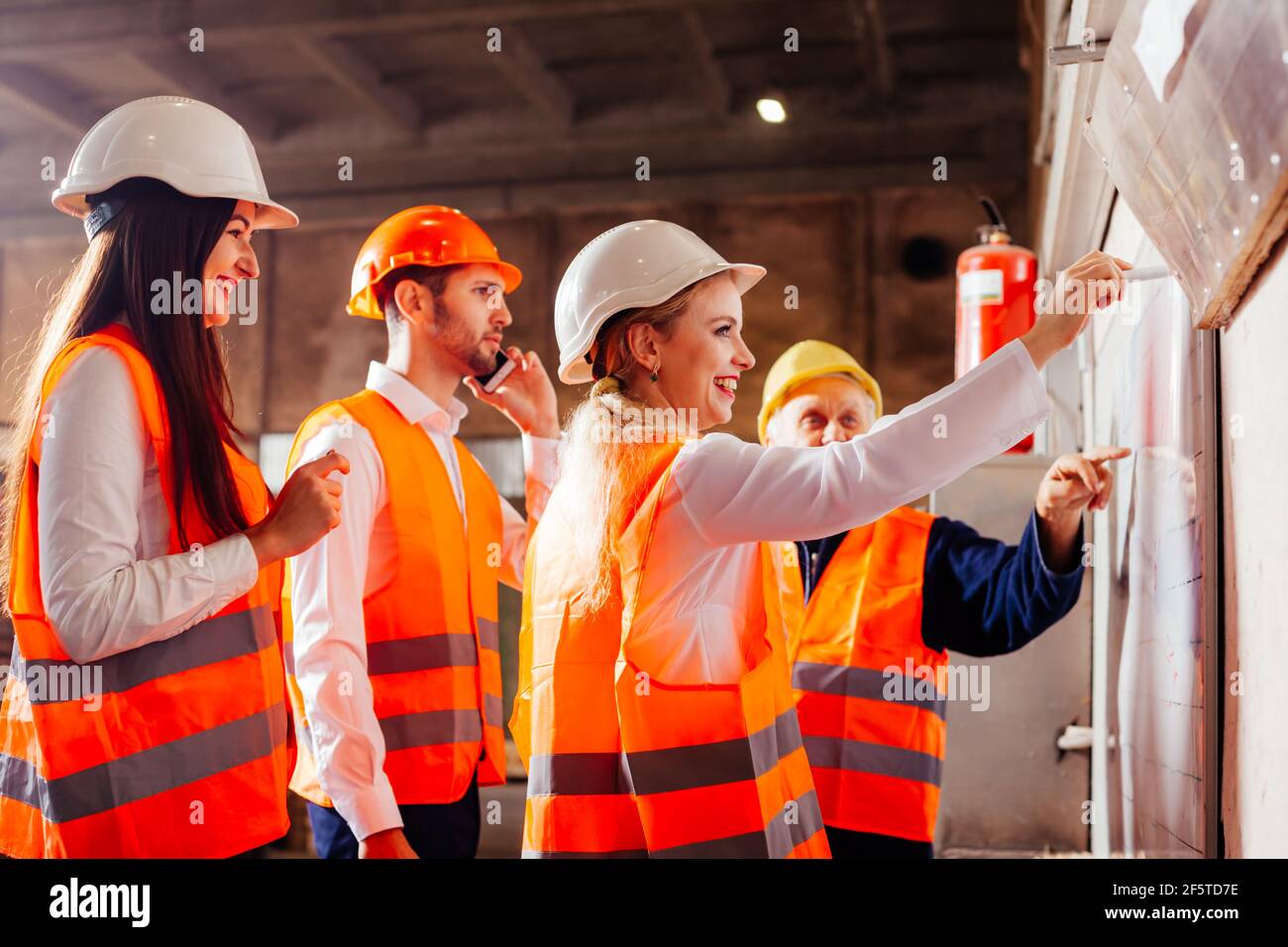 The workers draw up a plan of work at the plant Stock Photo - Alamy