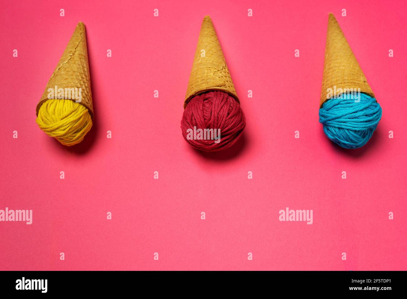 Colorful woolen thread balls in natural crunchy cones representing ...