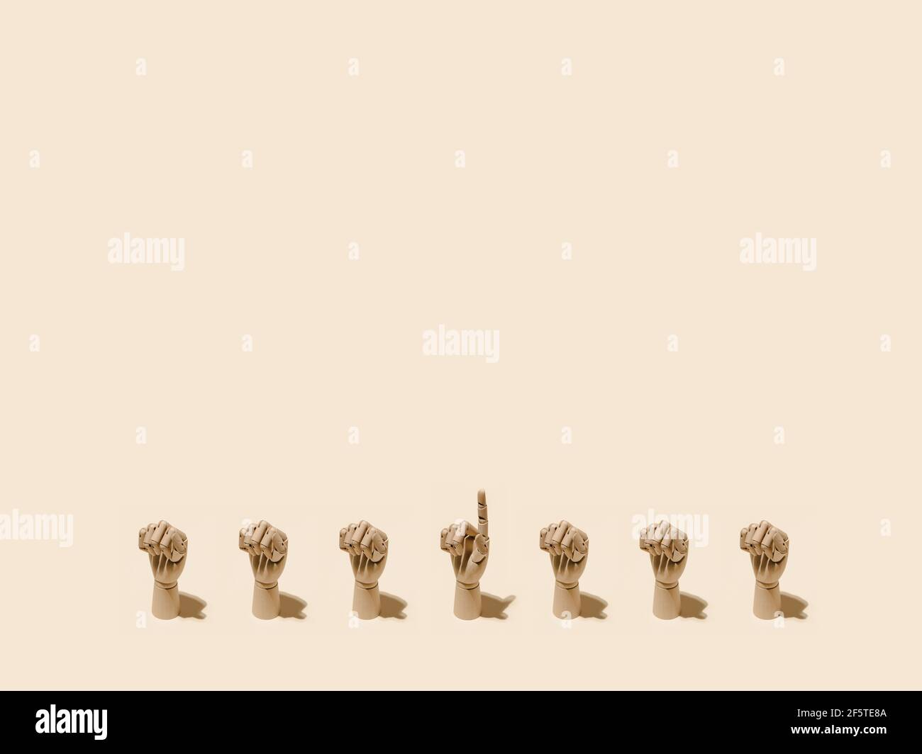 From above of pattern of wooden hands with clenched fists and one with ...