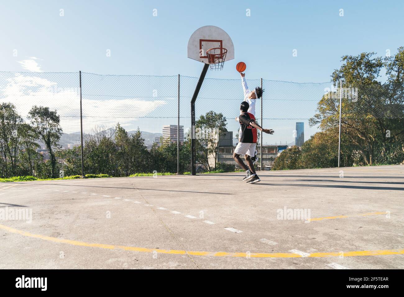 Side view of African American male and hispanic friend playing ...
