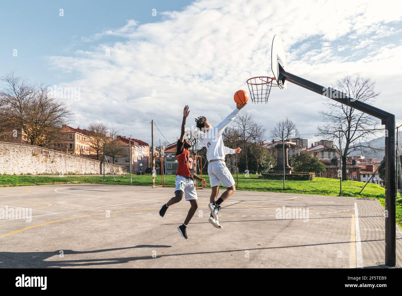 Side view of African American male and hispanic friend playing ...
