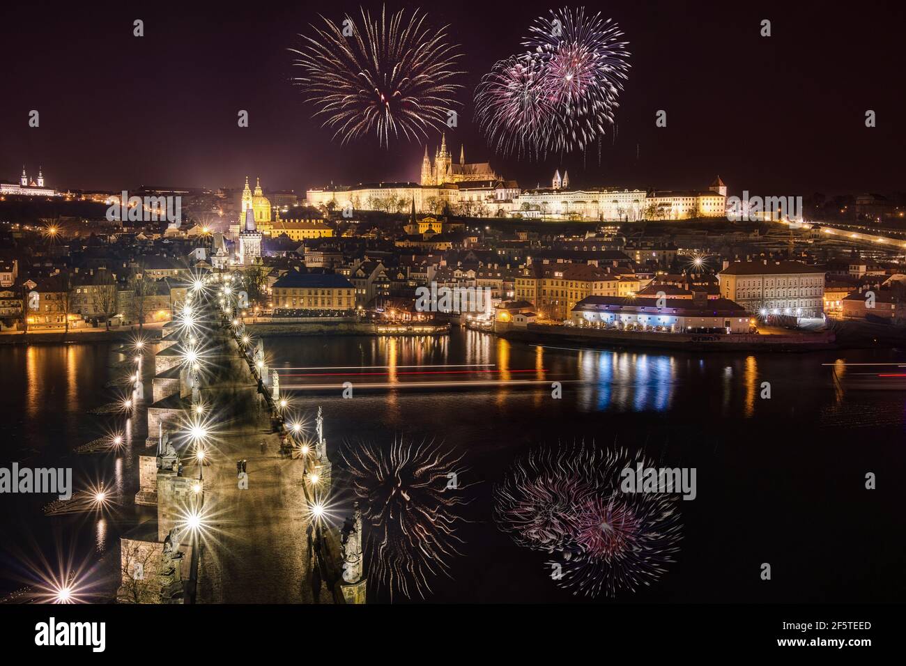 Amazing view of bright fireworks exploding in dark night sky over city ...