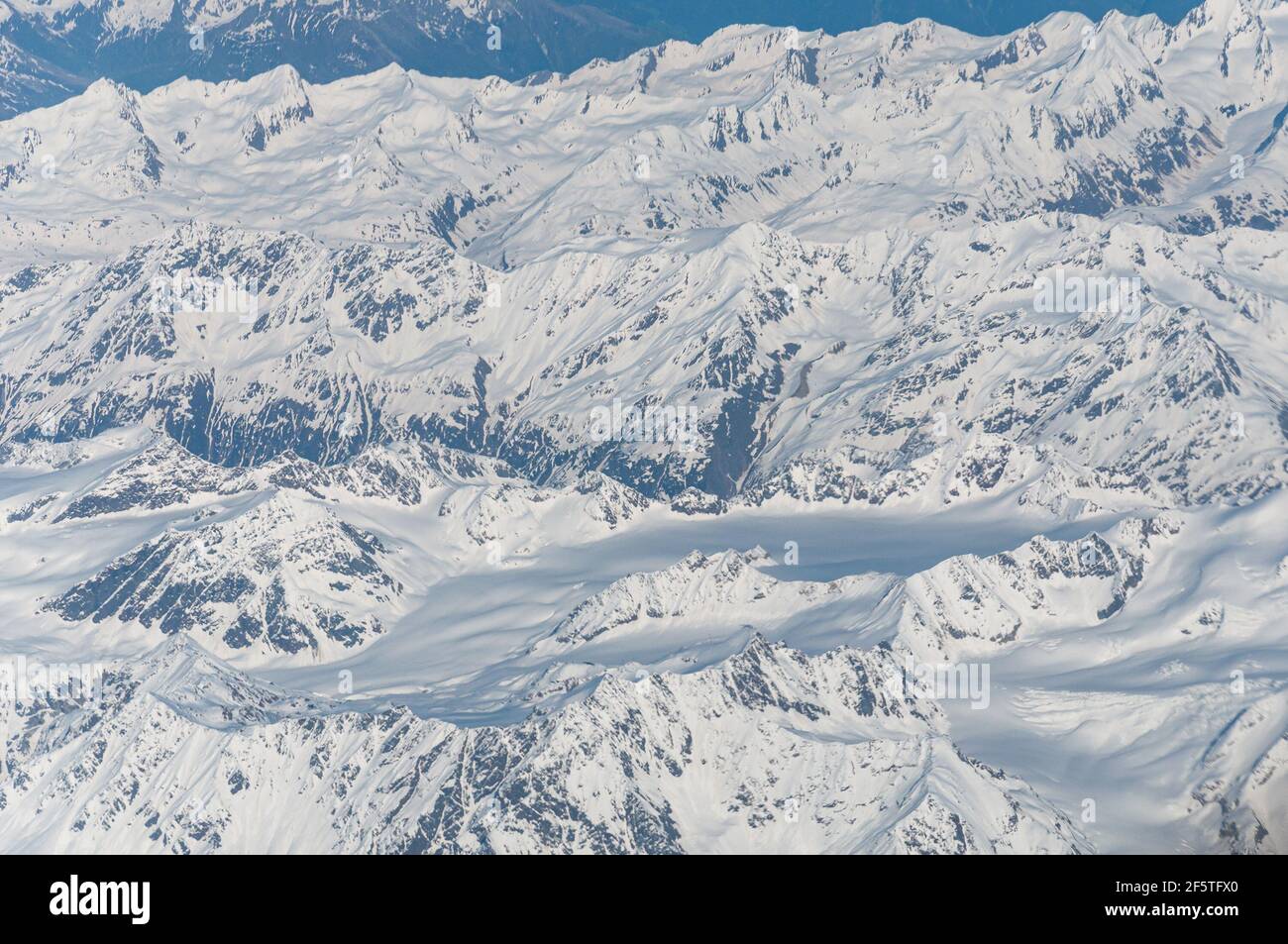 Glaciers and snow-capped peaks of the Alps seen from the plane. Concept ...