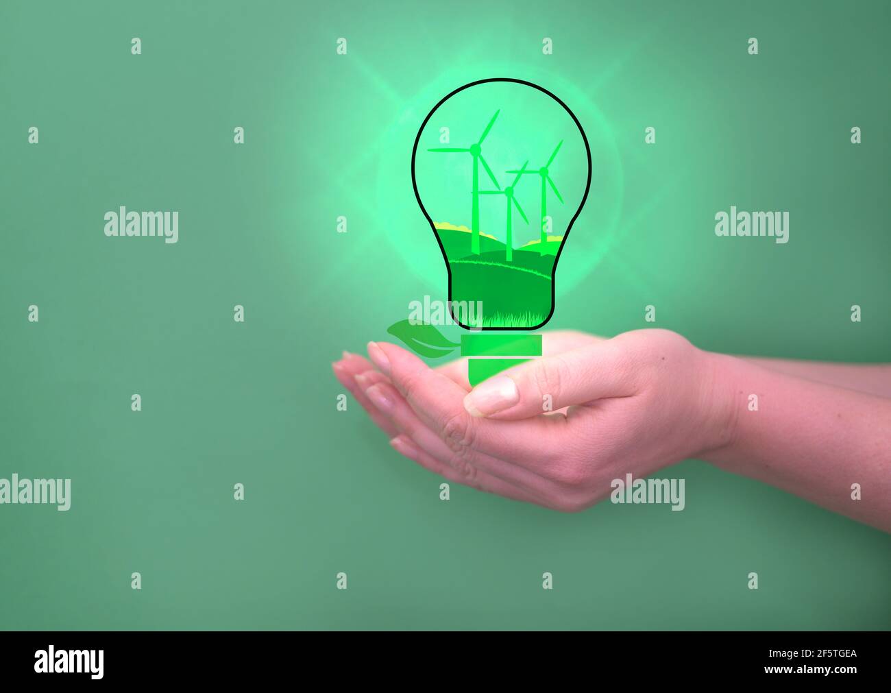 Hand holding green glowing light bulb. Corporate Social Responsibility ...