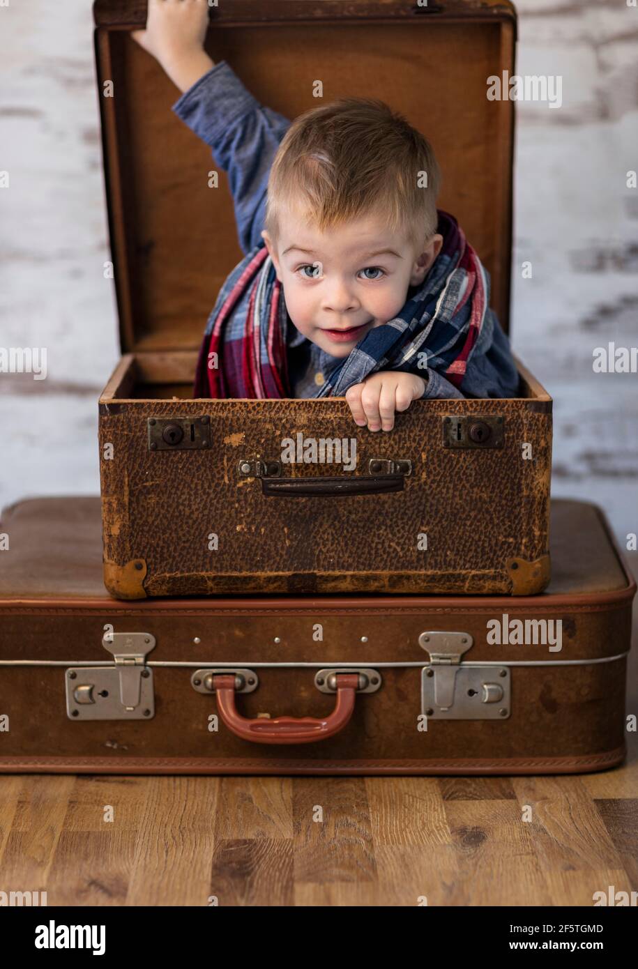 little boy playing in a suitcase, concept childhood and travel Stock ...