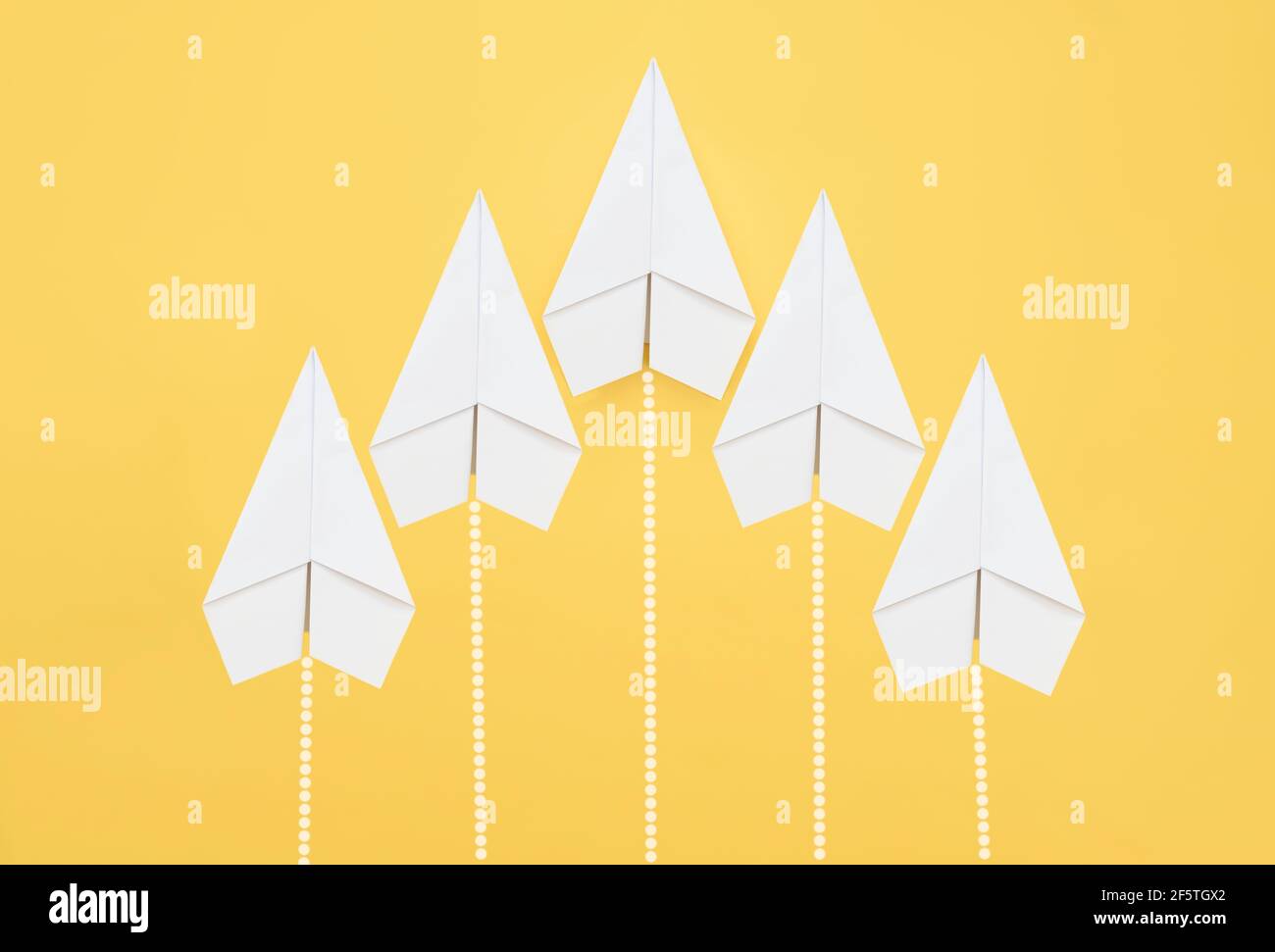 Paper planes on yellow background. Business strategy, marketing, idea ...