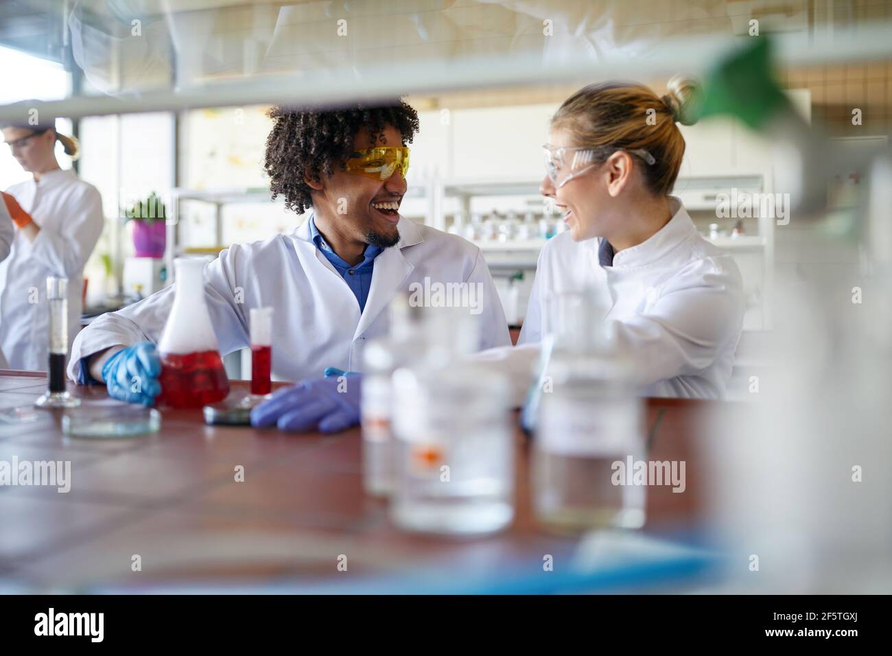 Young scientists enjoy while work in the sterile laboratory environment ...