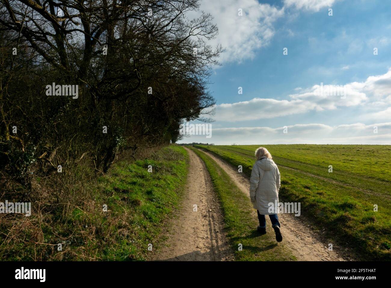 Woman on country walk Farm track Stock Photo - Alamy