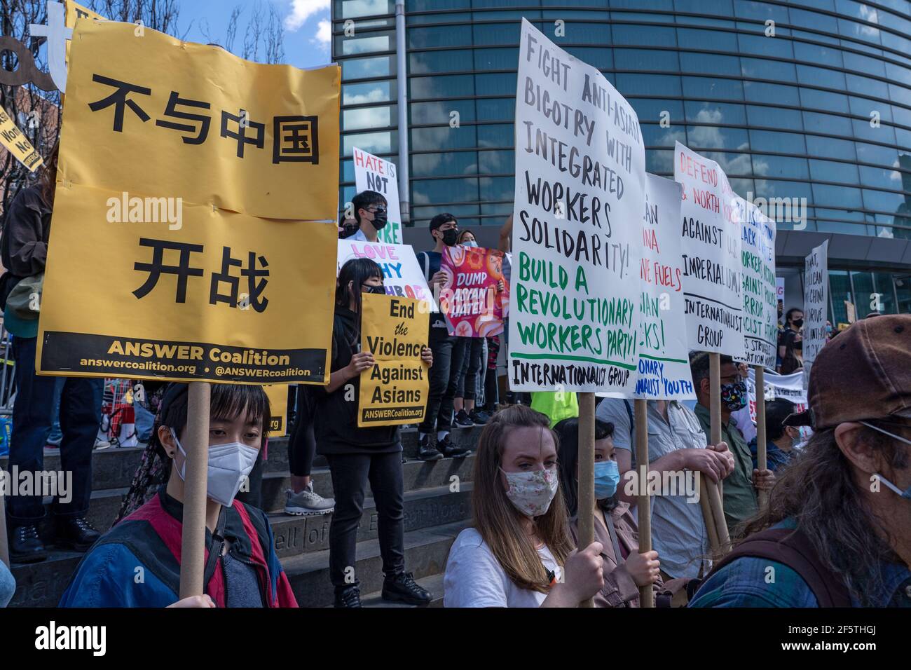 Supporters of the Asian-American community hold placards during the ...