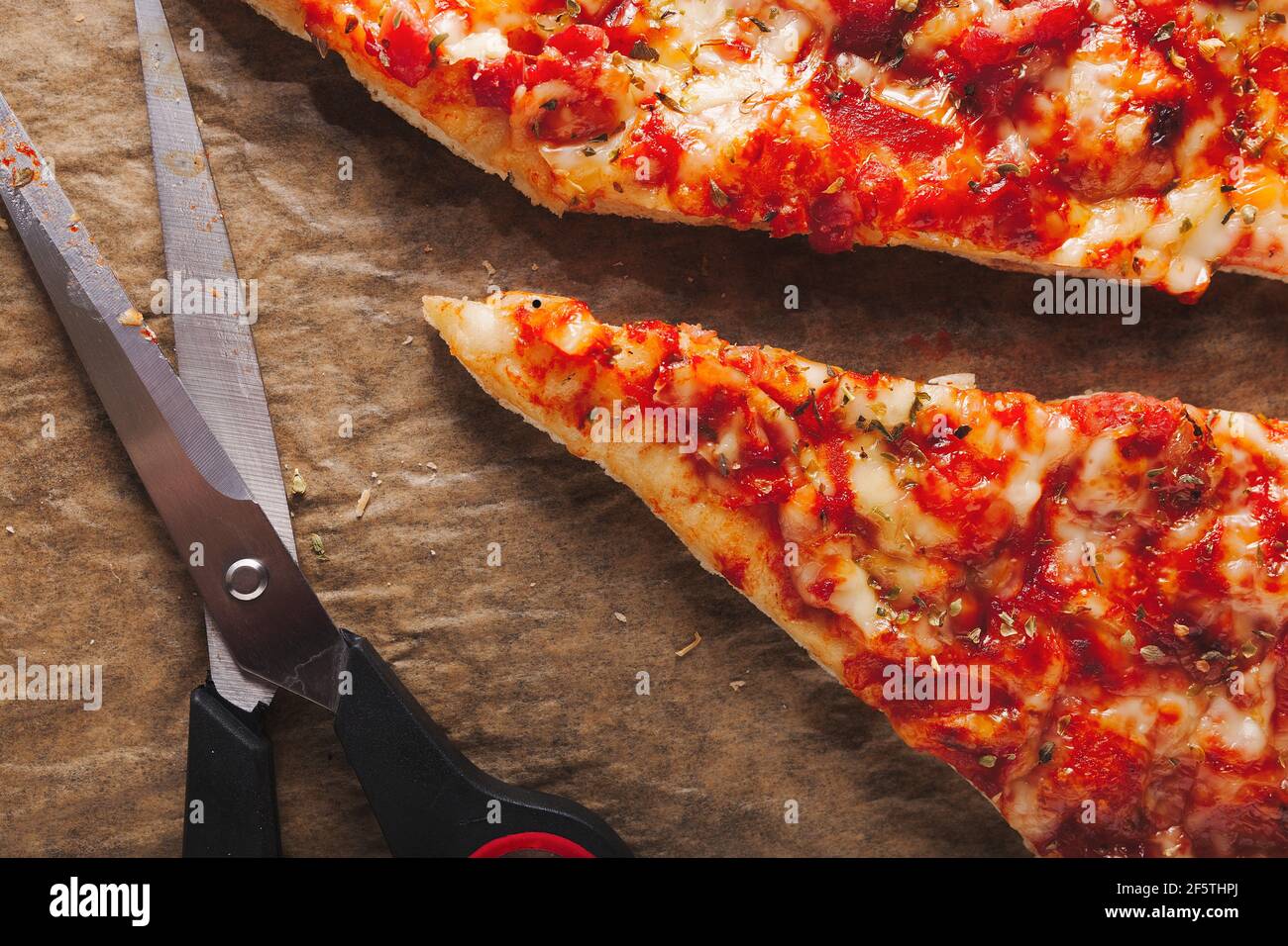 Slices of freshly made homemade pizza, cut in triangles with kitchen ...