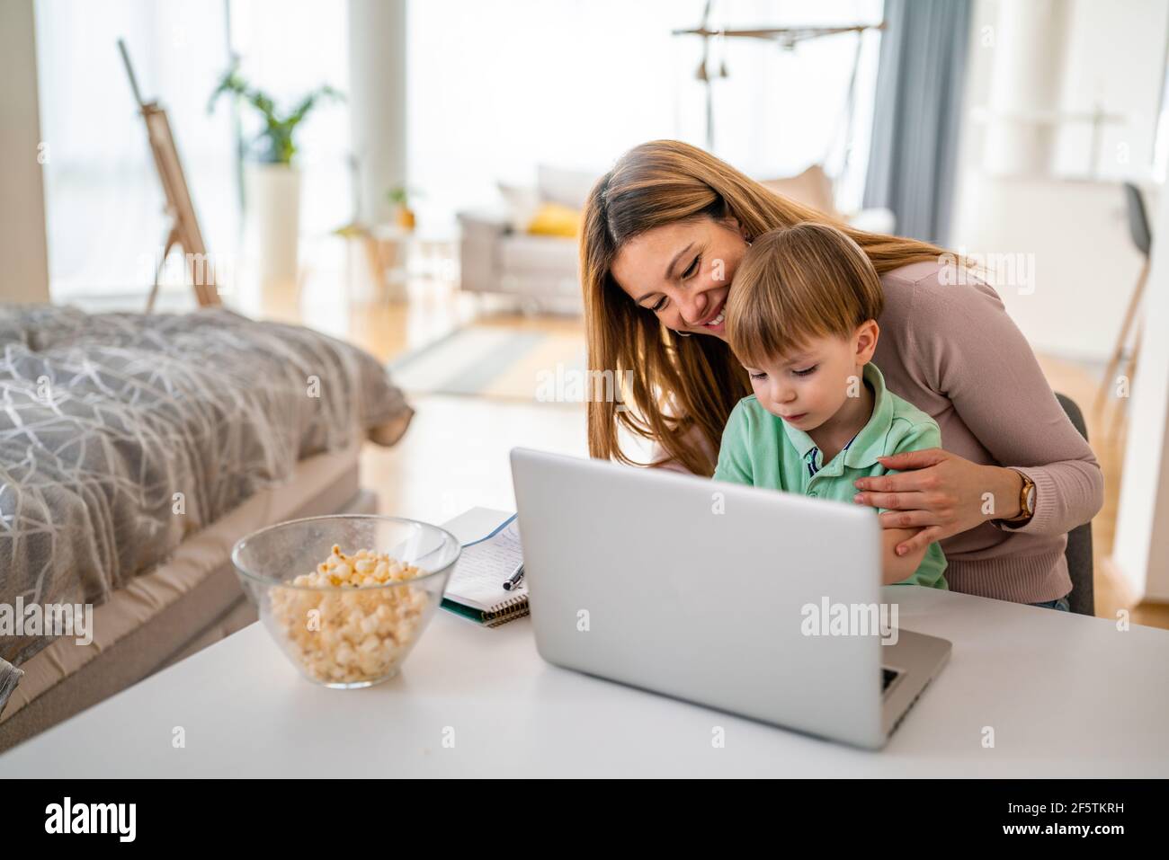 Mother working at home-office with child on her lap Stock Photo - Alamy