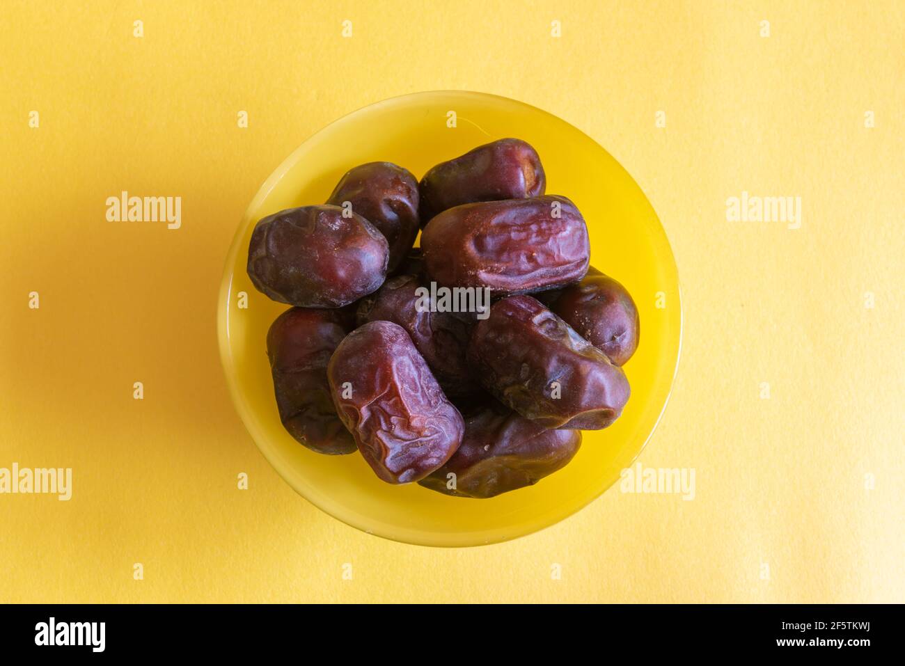 A top view of delicious Iranian dates in a yellow bowl Stock Photo - Alamy