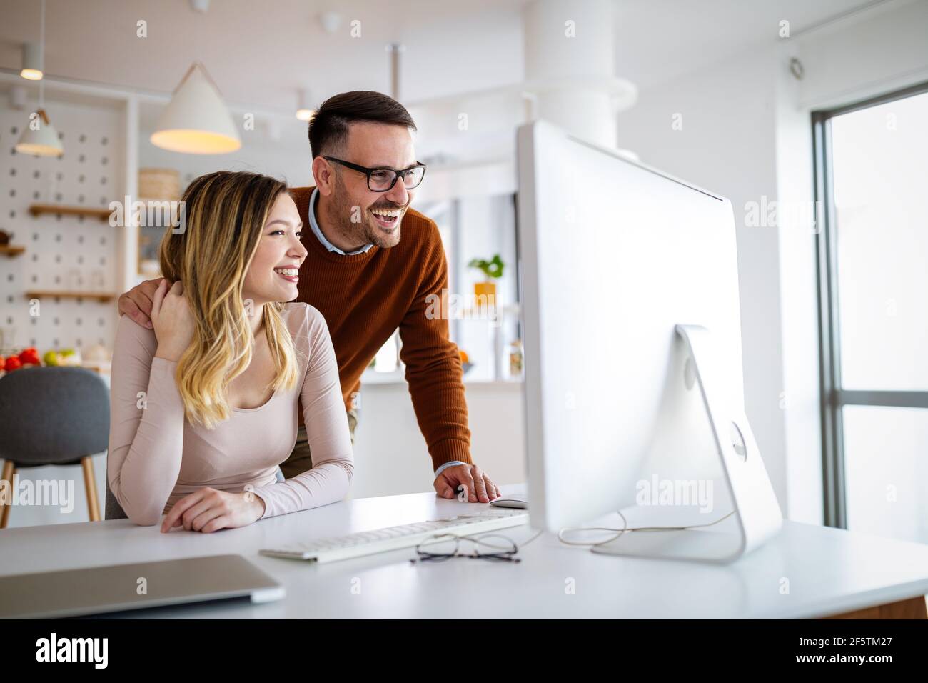 Happy couple in love working together on computer Stock Photo - Alamy