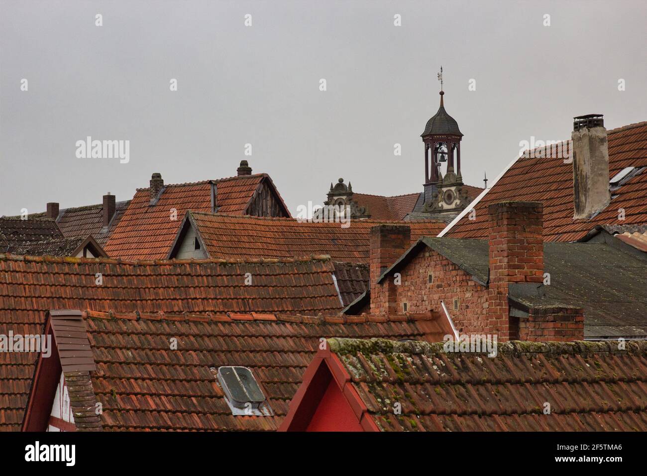 The brown building roofs and a church tower Stock Photo - Alamy