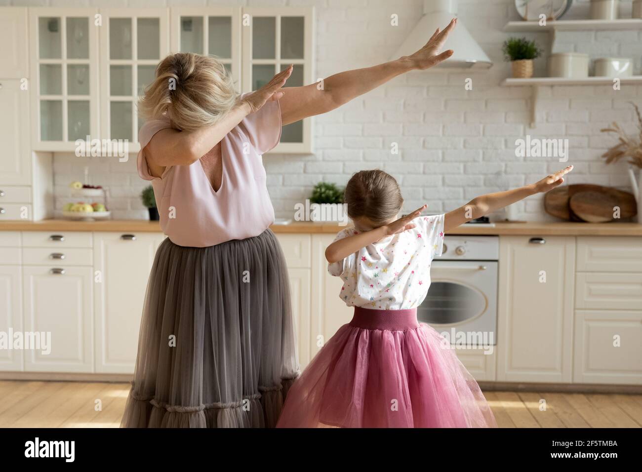 Modern grandmother dab dancing with small granddaughter Stock Photo - Alamy