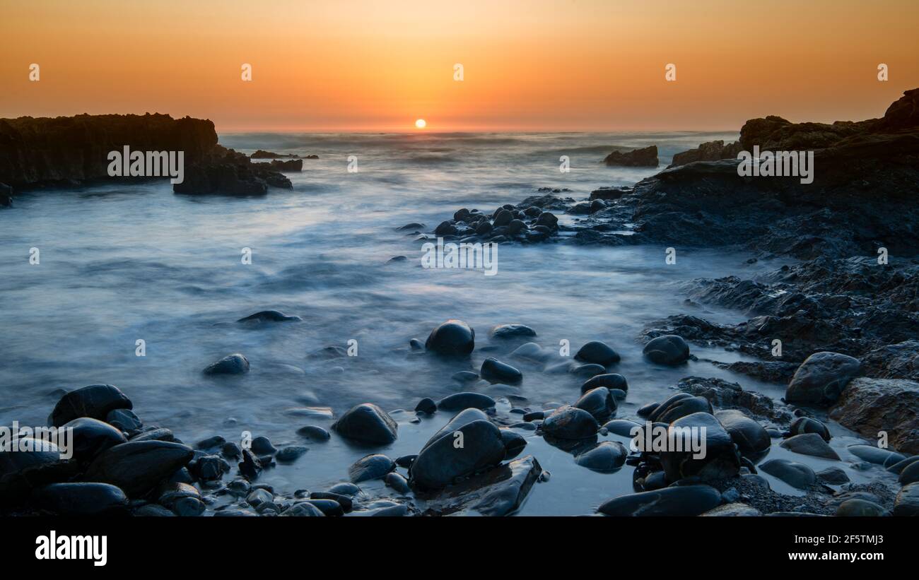 A beautiful quiet beach during sunset, long exposure Stock Photo - Alamy