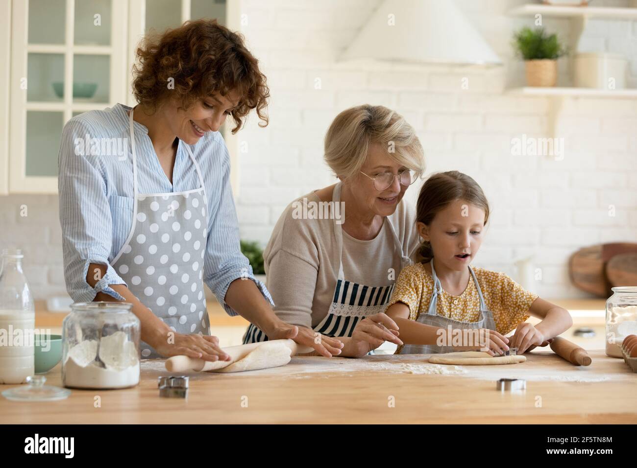 Happy three generations of women baking together Stock Photo - Alamy