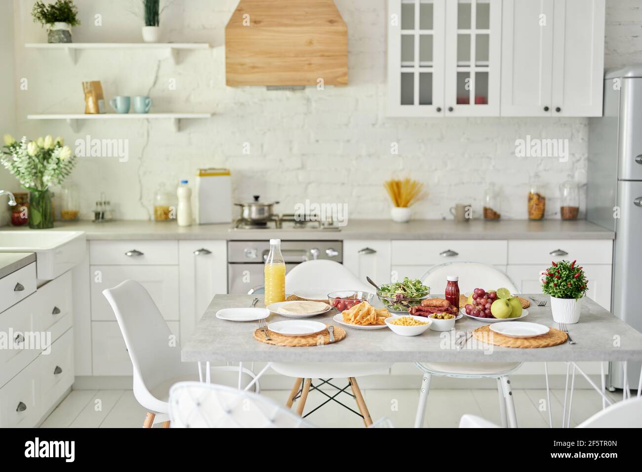 Latin style breakfast on the table. Modern bright white kitchen ...