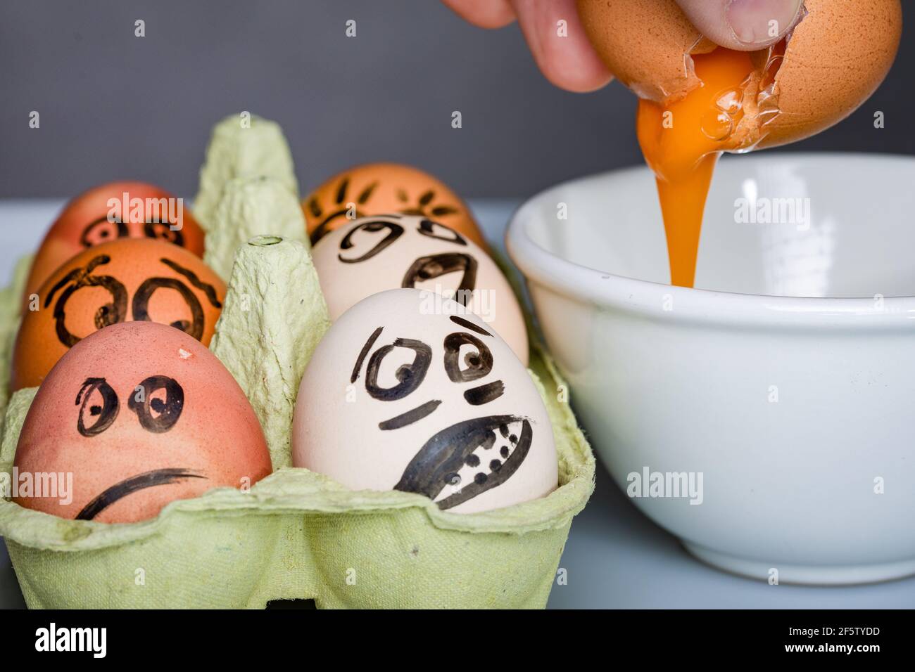 Crazy eggs terrified, Scared faces staring from egg tray at broken egg ...